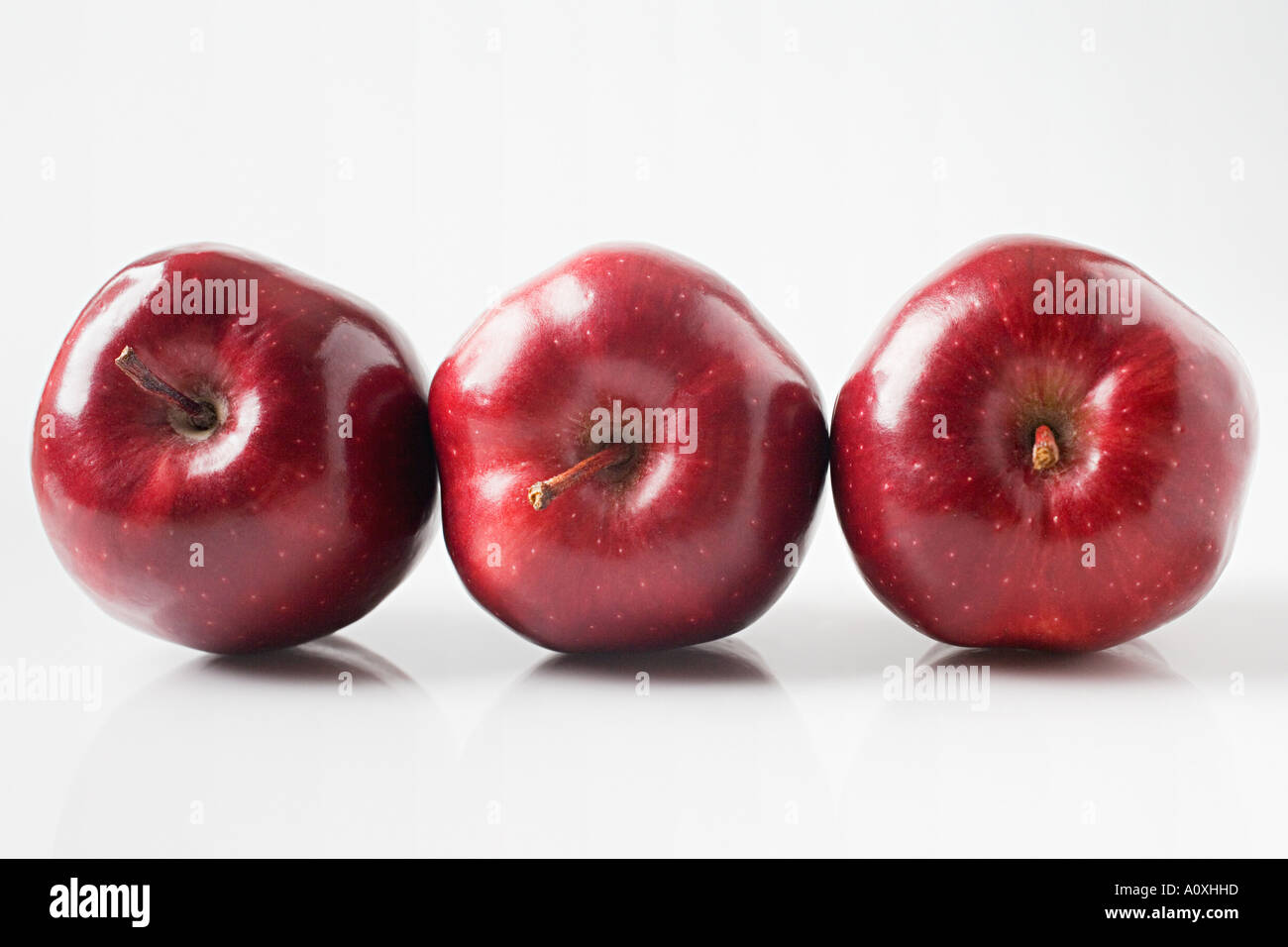 Three red apples Stock Photo - Alamy