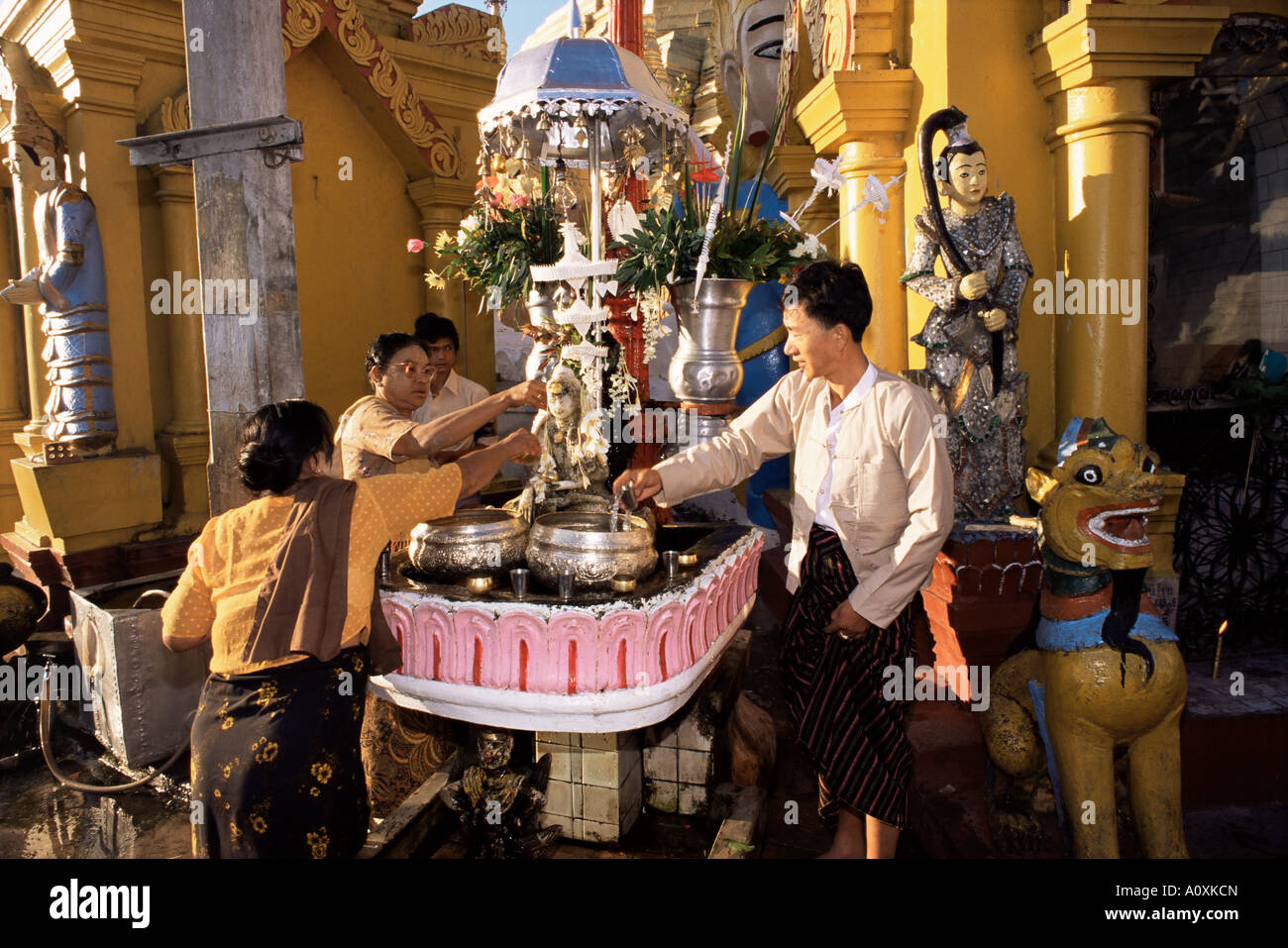 Pouring water on the Buddha Shwedagon Pagoda Yangon Rangoon Myanmar ...