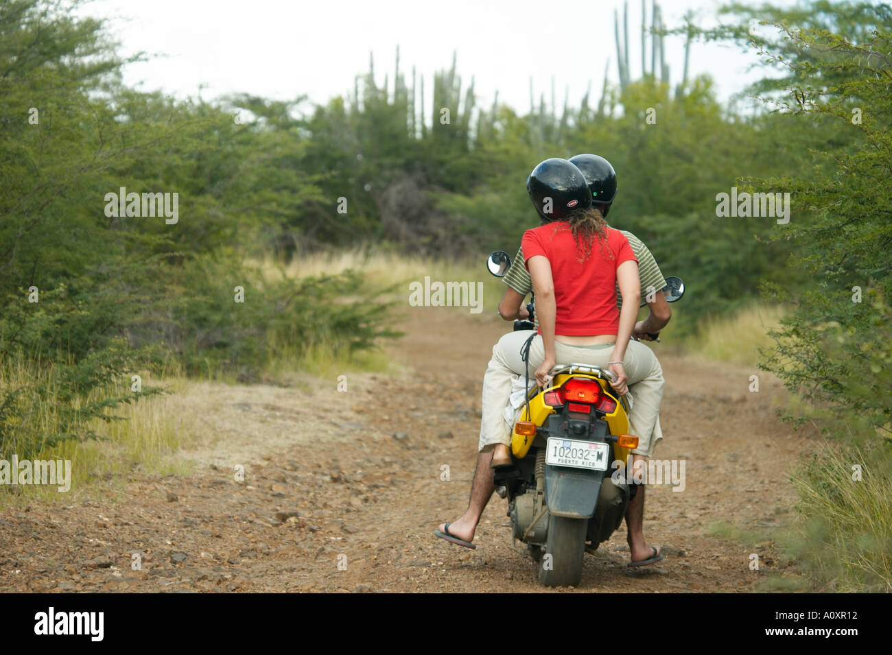 PUERTO RICO Culebra Young couple on small motorbike dirt road to Punta ...