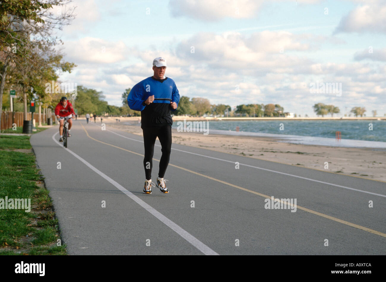 RUNNING Chicago Illinois Runner on paved path along Oak Street Beach ...