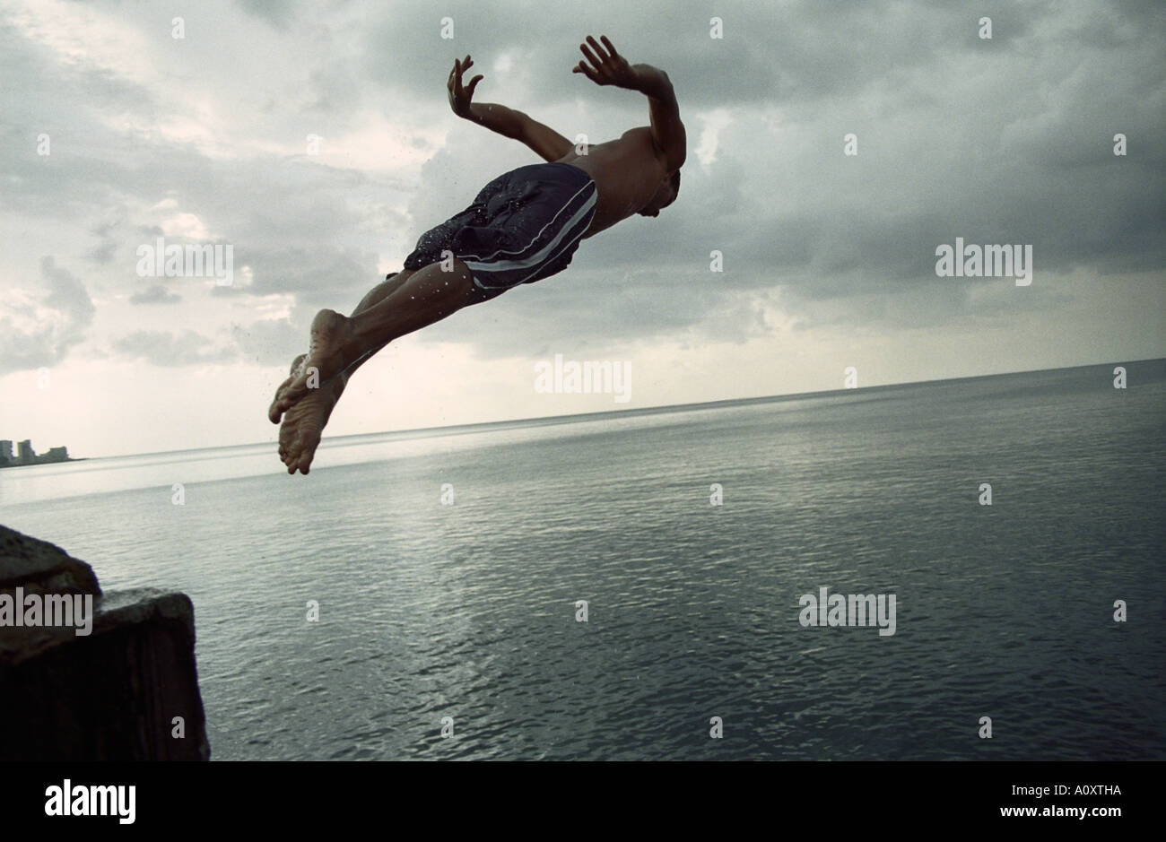 CUBA HAVANA Young Cuban diving into the sea from The Malecon seawall ...