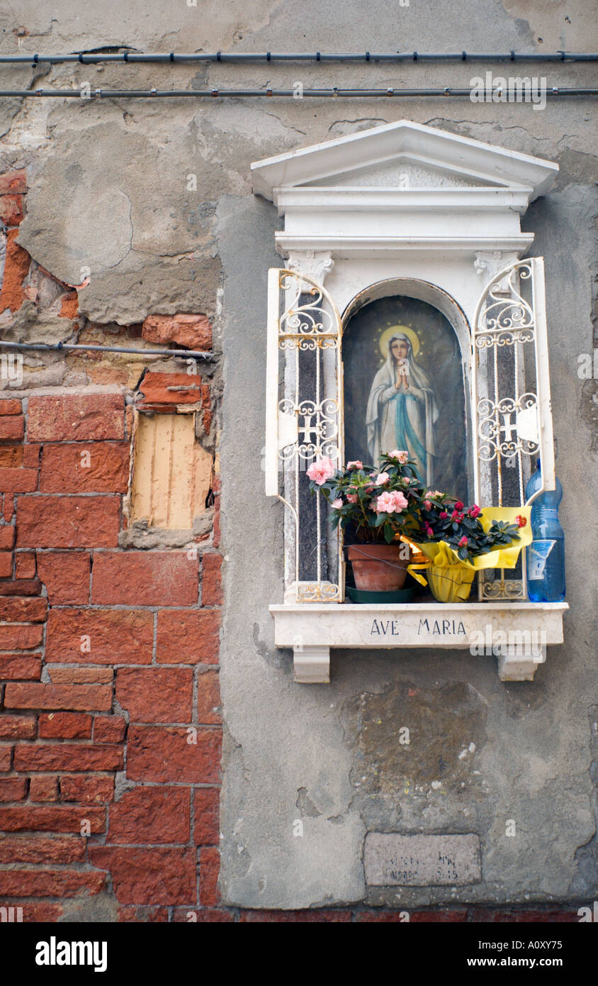 Roman Catholic icon showing Virgin Mary on wall in a side street in ...