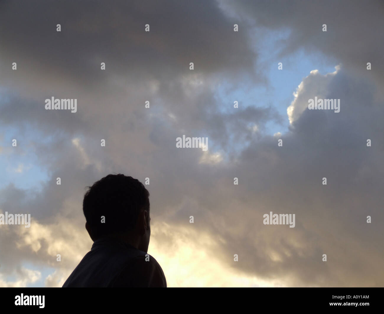 backlit person against dramatic sky Stock Photo - Alamy