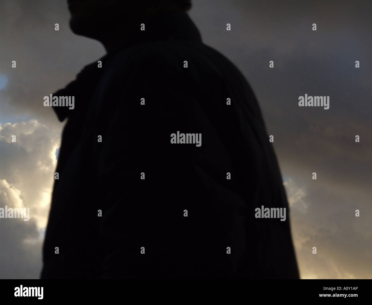 backlit person against dramatic sky Stock Photo - Alamy