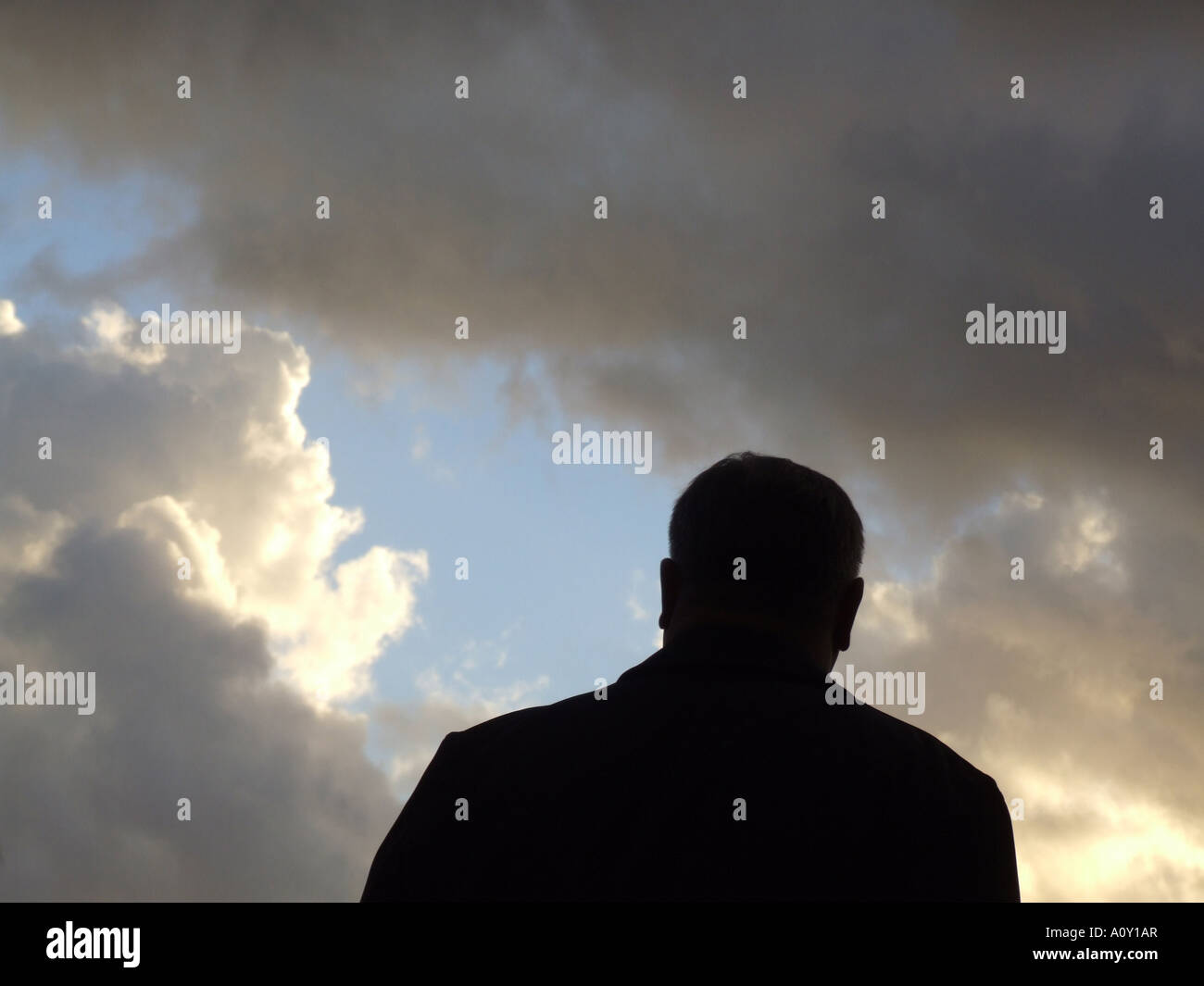 backlit person against dramatic sky Stock Photo - Alamy