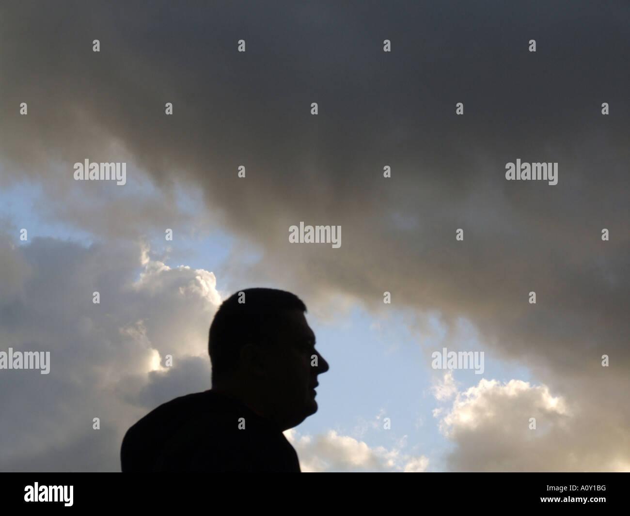 backlit person against dramatic sky Stock Photo - Alamy