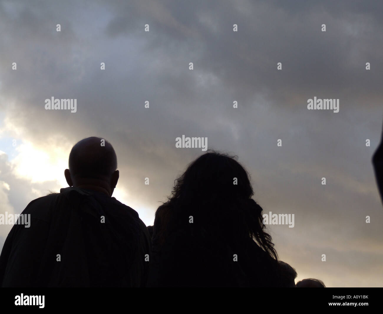 backlit people against dramatic sky Stock Photo - Alamy