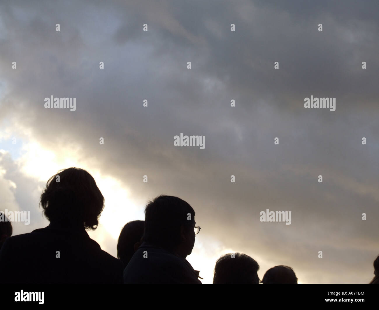 backlit people against dramatic sky Stock Photo - Alamy