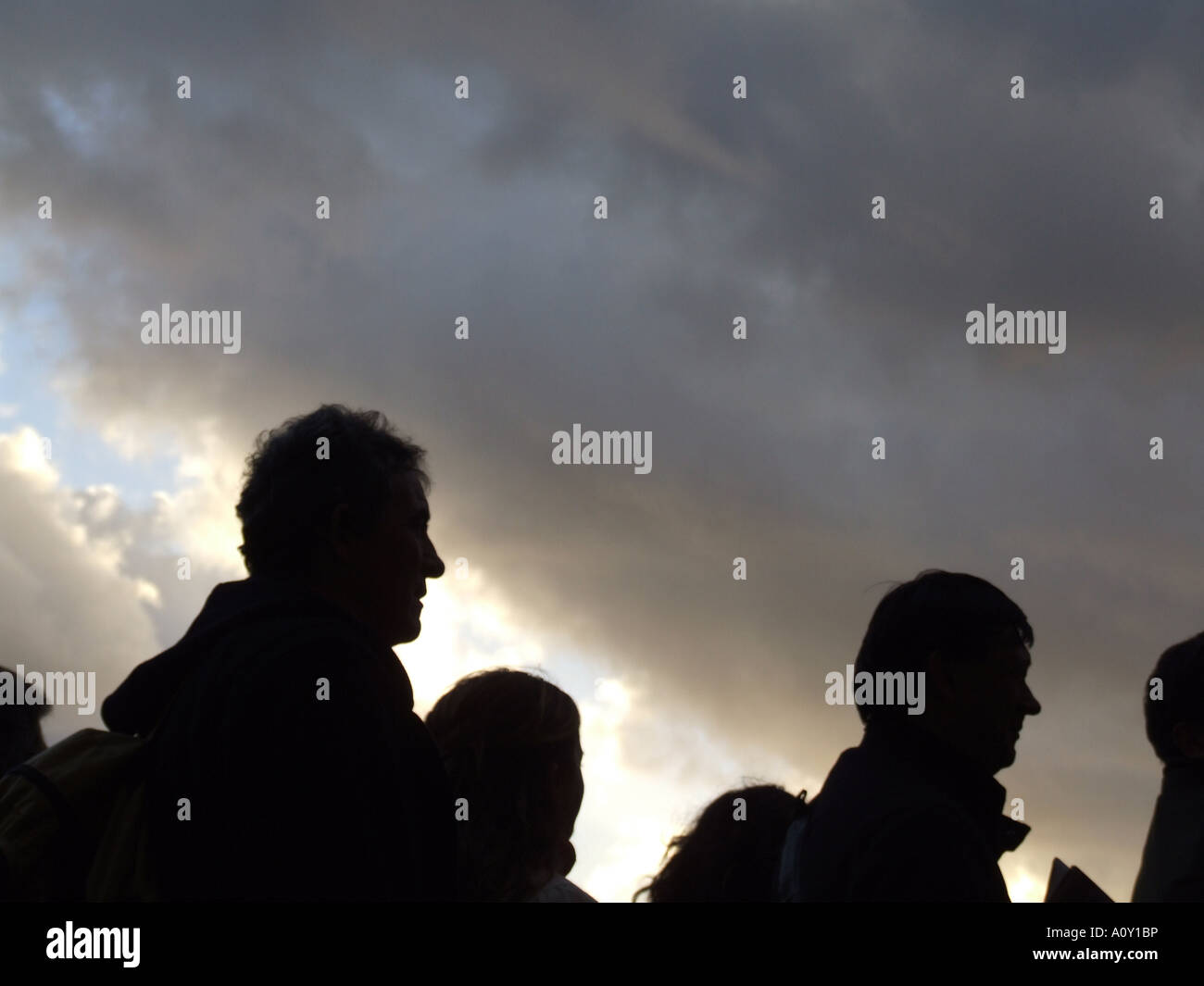 backlit people against dramatic sky Stock Photo - Alamy