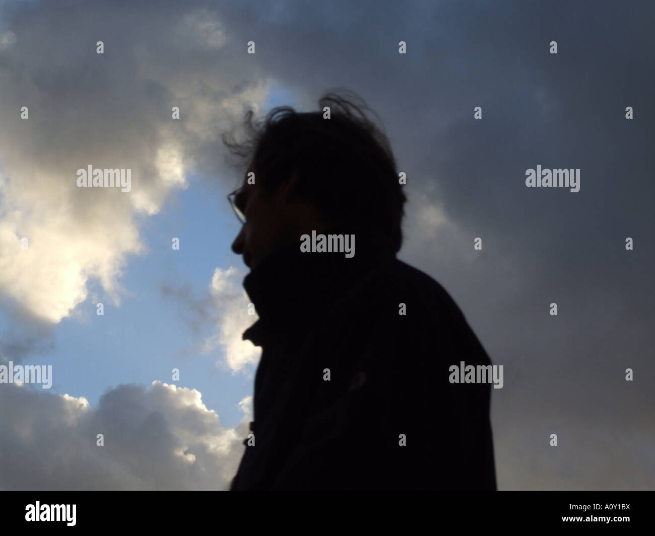 backlit person against dramatic sky Stock Photo - Alamy