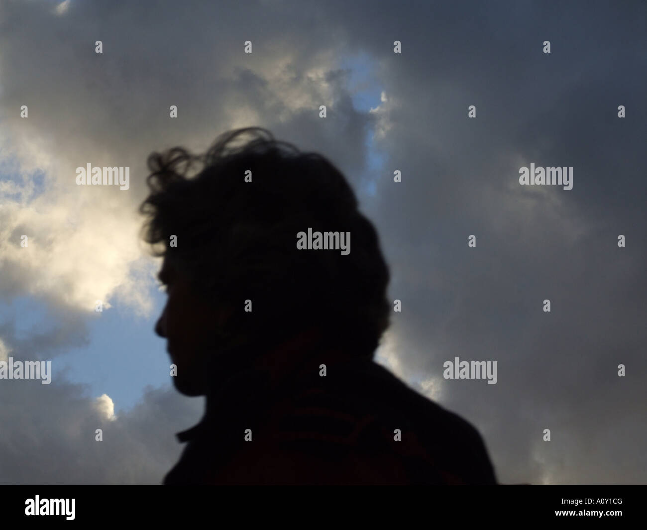 backlit person against dramatic sky Stock Photo - Alamy