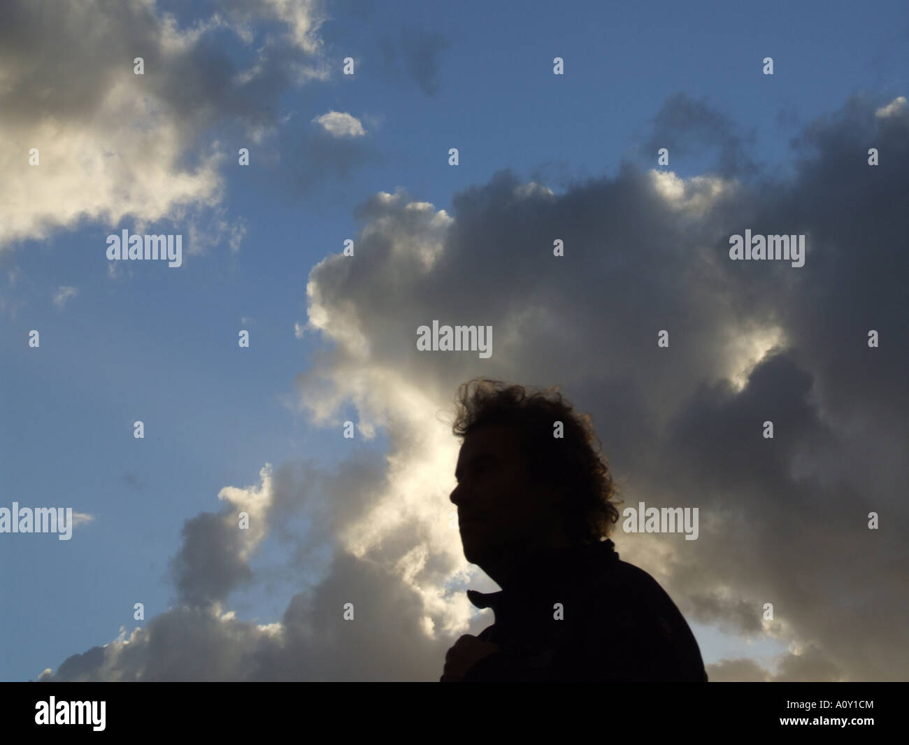 backlit person against dramatic sky Stock Photo - Alamy