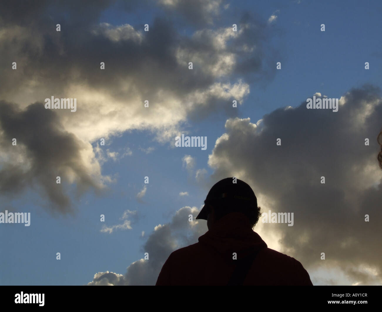 backlit person against dramatic sky Stock Photo - Alamy