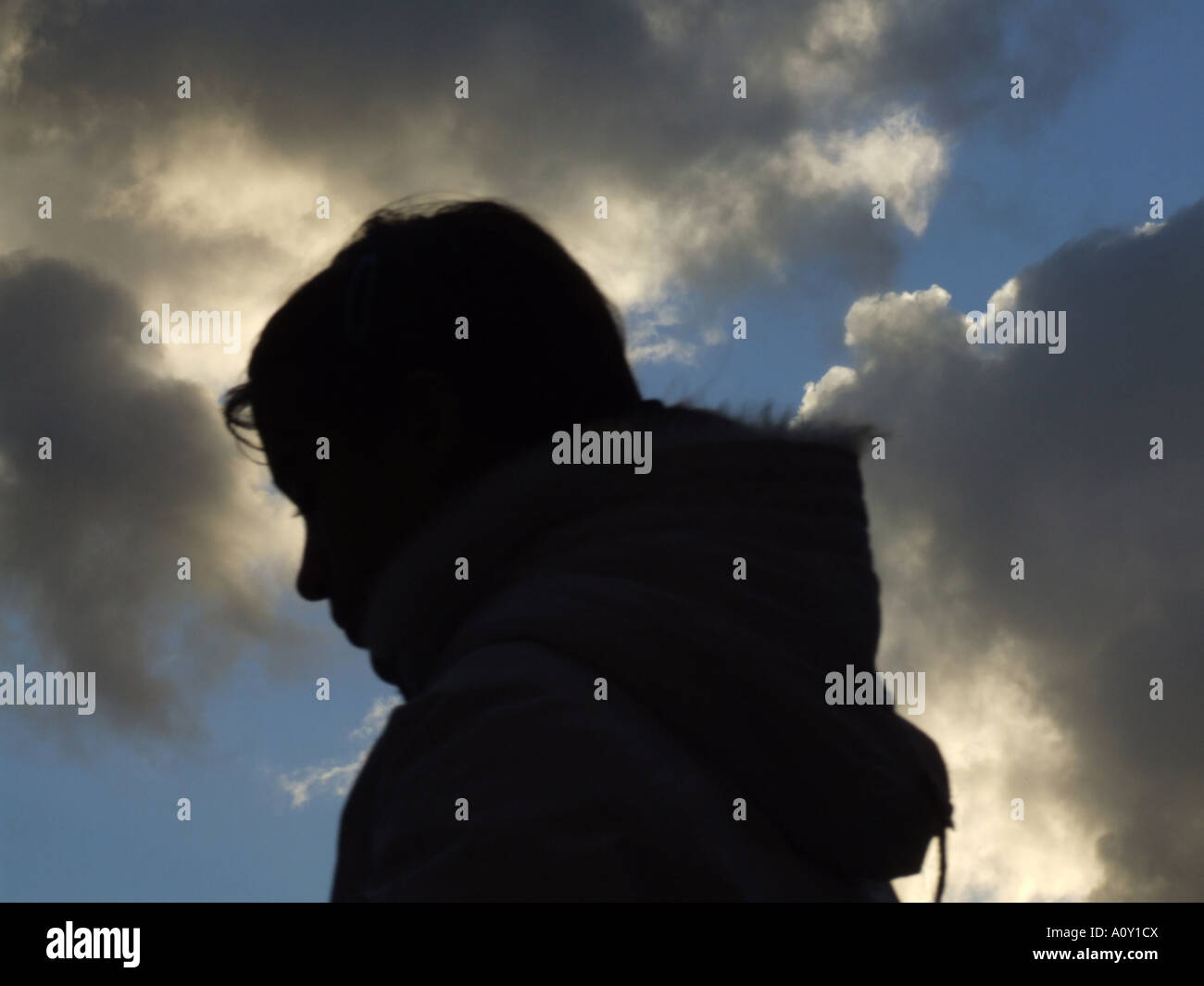 backlit person against dramatic sky Stock Photo - Alamy