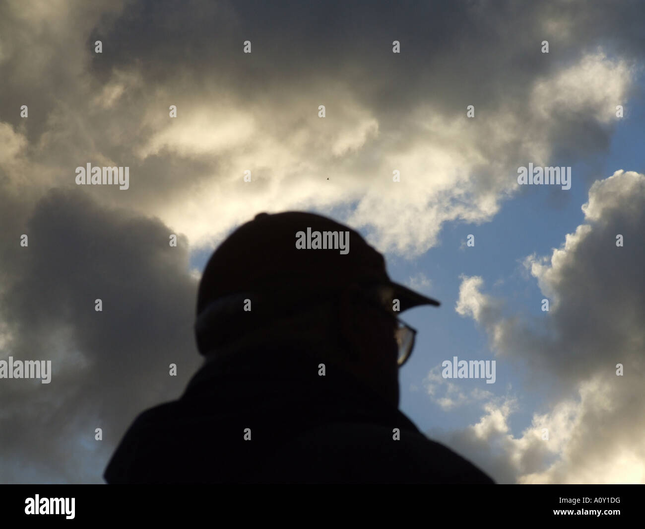 backlit person against dramatic sky Stock Photo - Alamy