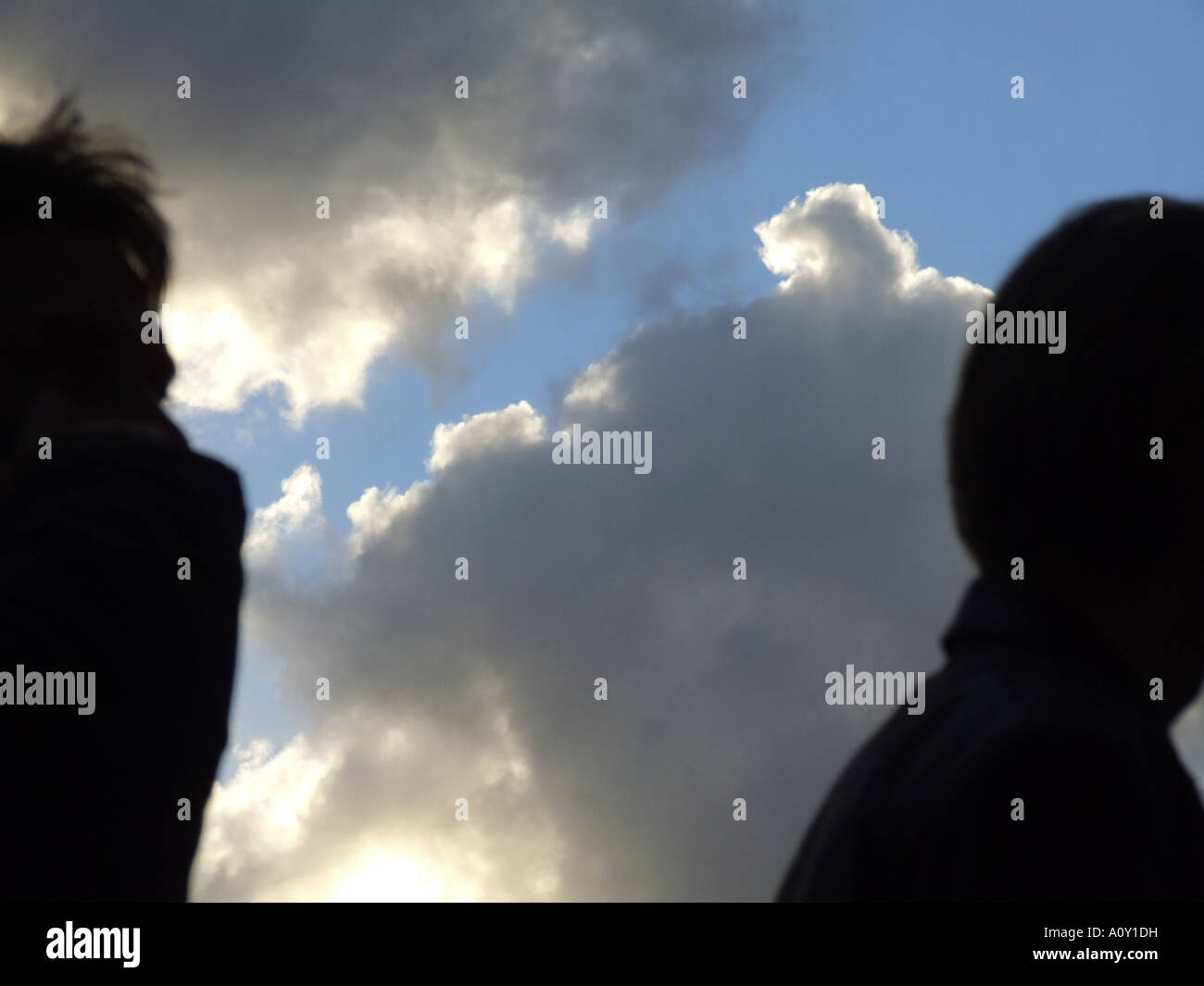 backlit people against dramatic sky Stock Photo - Alamy