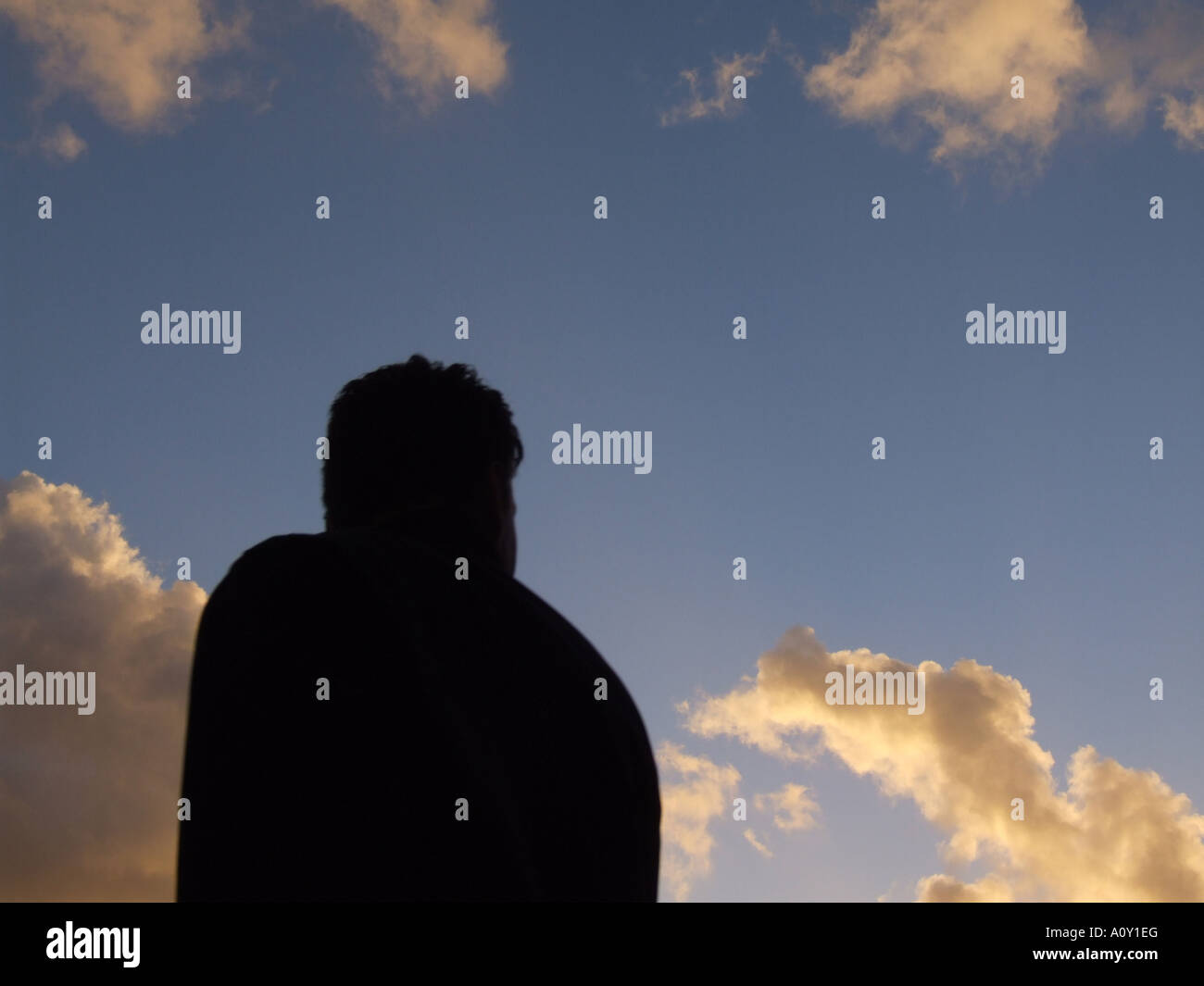 backlit person against dramatic sky Stock Photo - Alamy