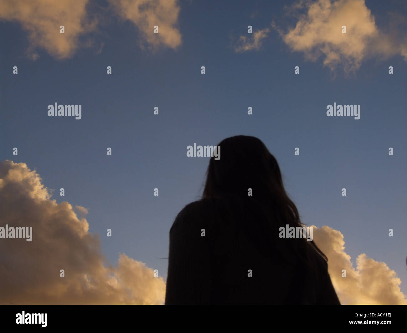 backlit person against dramatic sky Stock Photo - Alamy