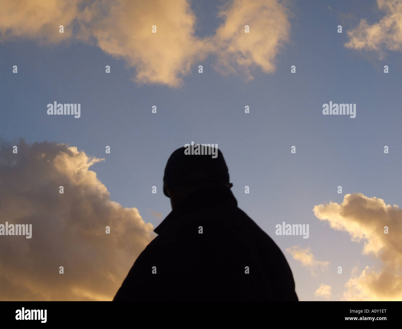 backlit person against dramatic sky Stock Photo - Alamy