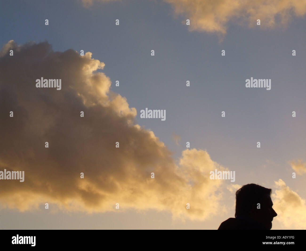 backlit person against dramatic sky Stock Photo - Alamy