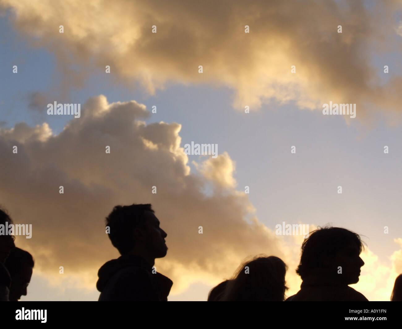 backlit people against dramatic sky Stock Photo - Alamy