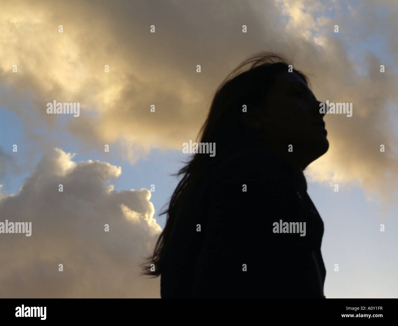 backlit person against dramatic sky Stock Photo - Alamy