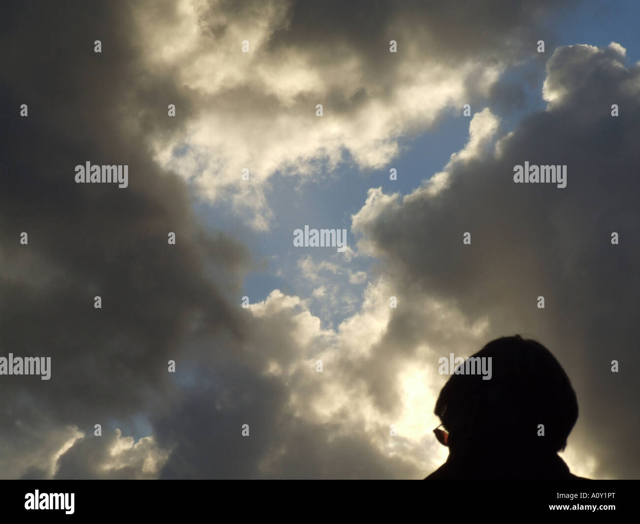 backlit person against dramatic sky Stock Photo - Alamy