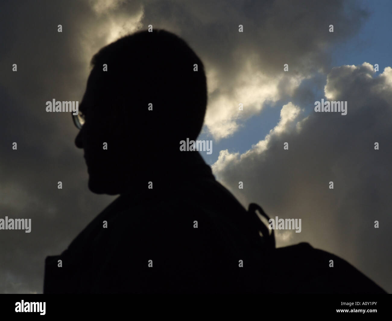 backlit person against dramatic sky Stock Photo - Alamy