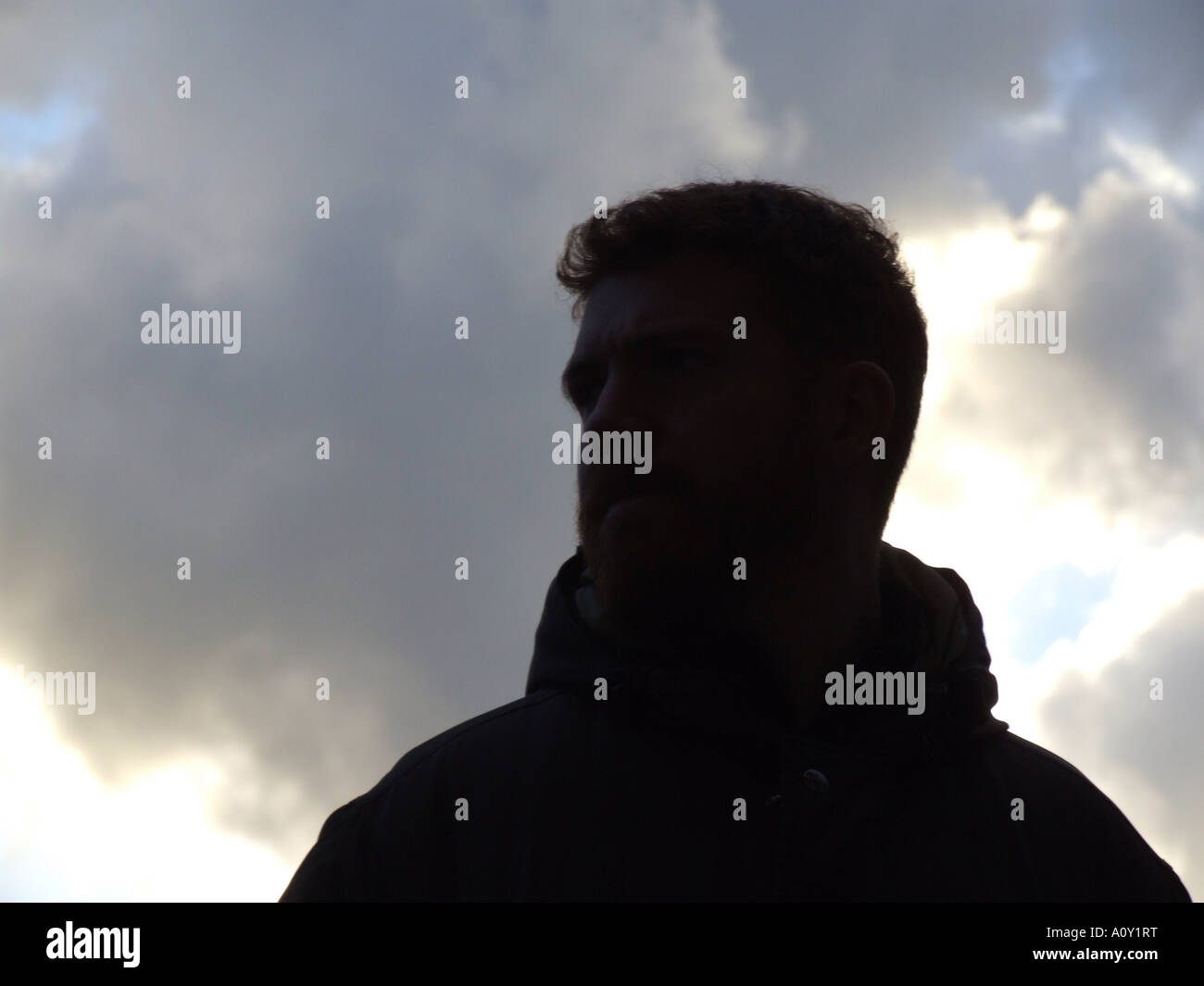 backlit person against dramatic sky Stock Photo - Alamy