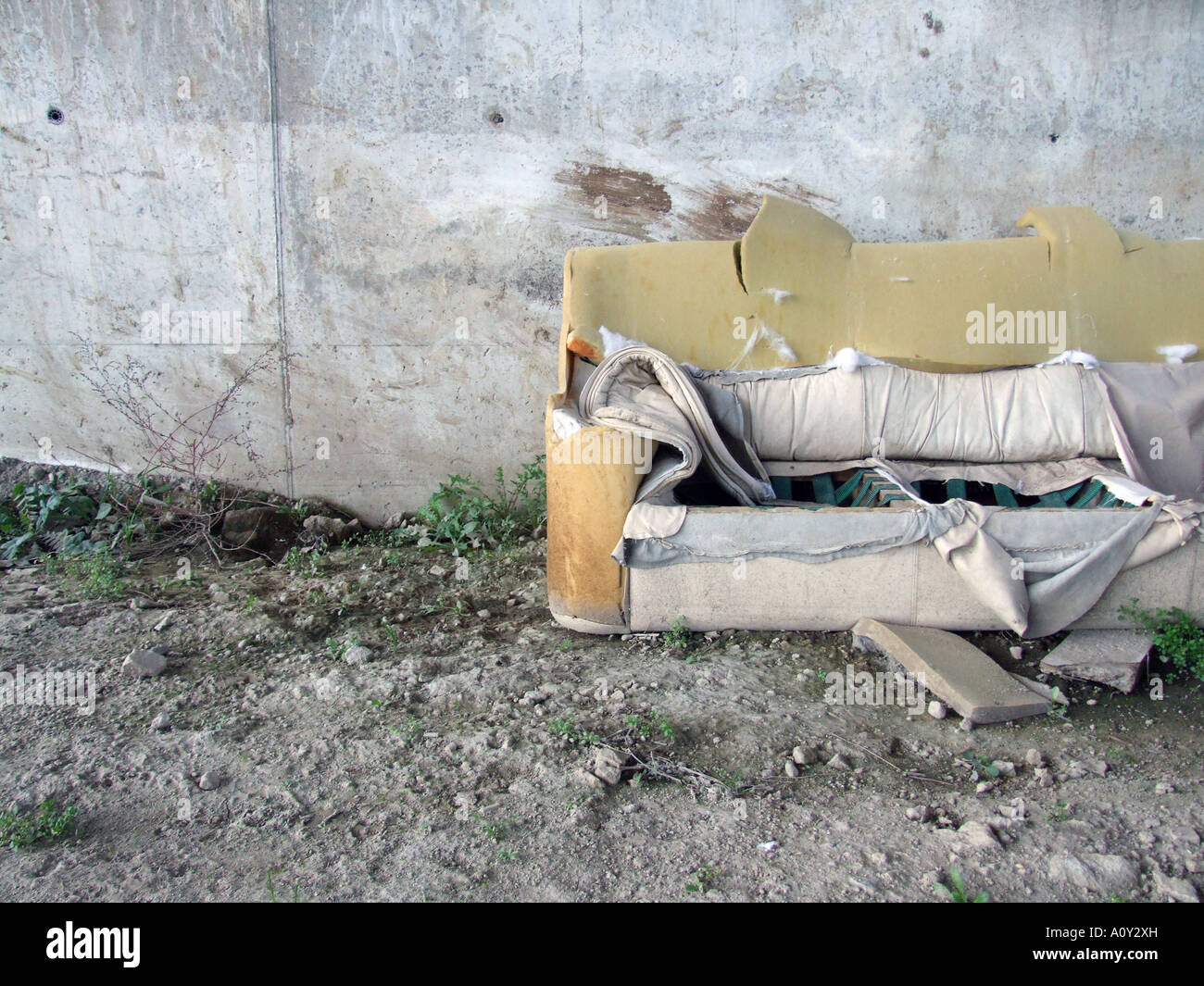 sofa dumped on derelict ground Stock Photo - Alamy