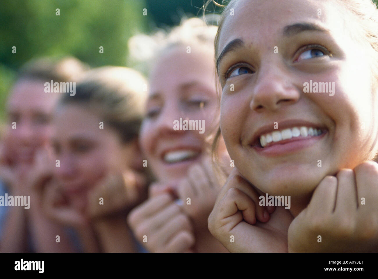 Side profile of four teenage girls smiling Stock Photo - Alamy