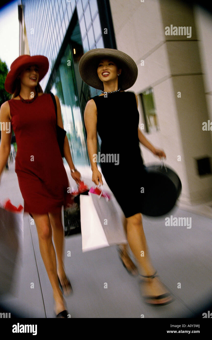 Low angle view of two young women carrying shopping bags Stock Photo ...