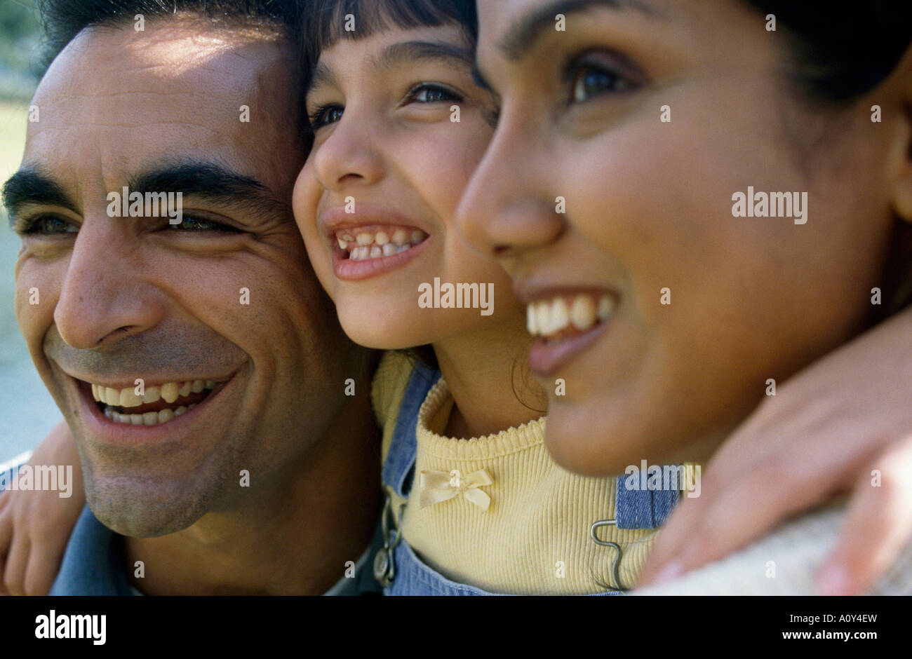 Close-up of parents smiling with their daughter Stock Photo - Alamy