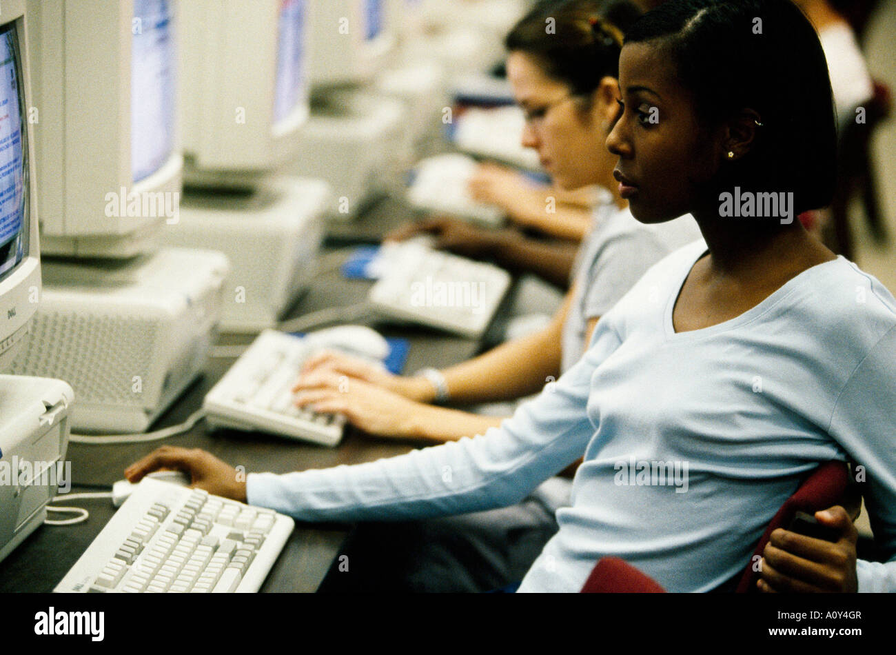 Side profile of two teenage girls working on computers Stock Photo - Alamy