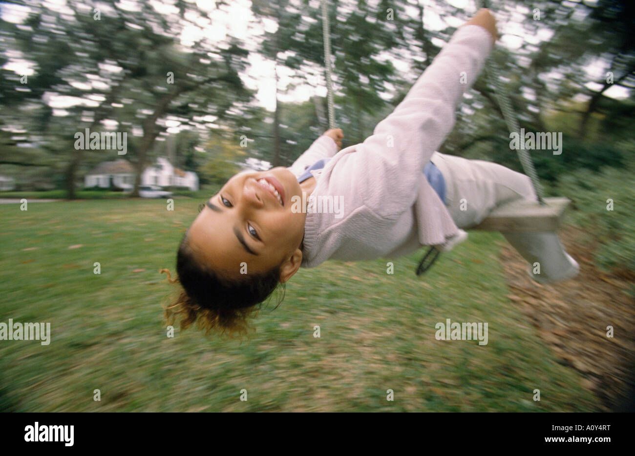Portrait of a girl swinging on a swing Stock Photo - Alamy