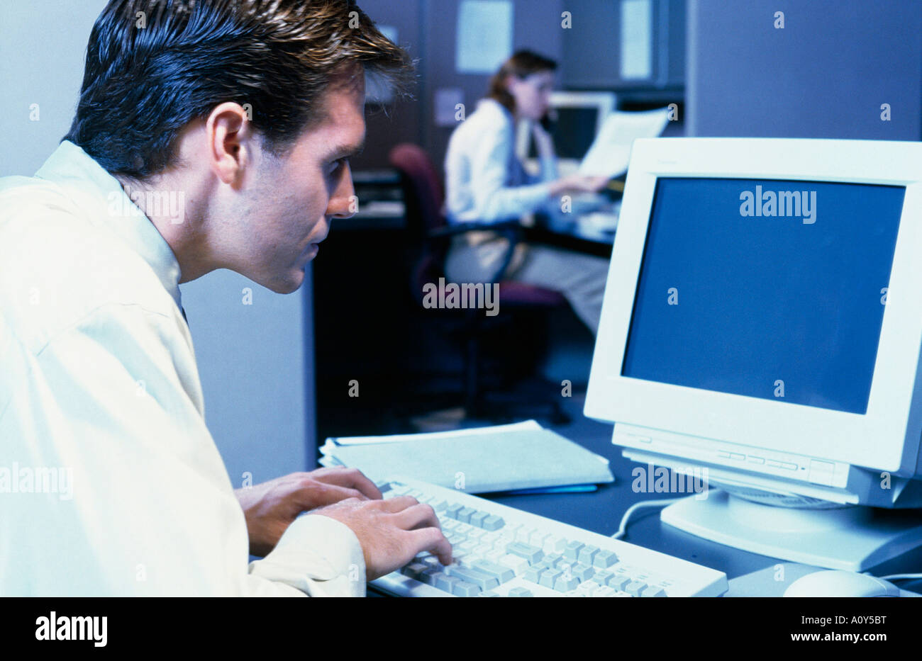Side profile of a businessman working on a computer Stock Photo - Alamy