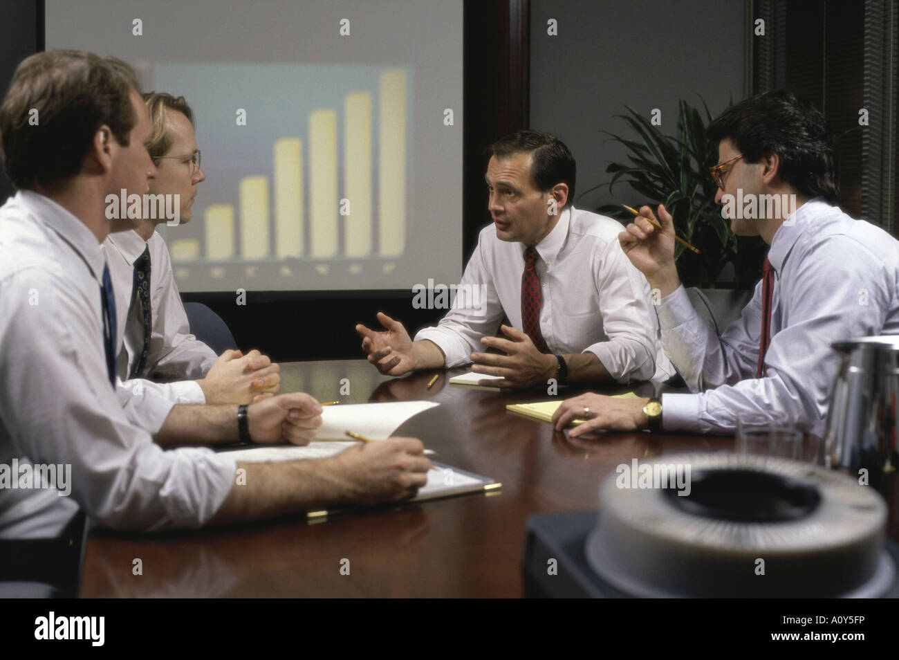 Four businessmen talking in a seminar Stock Photo - Alamy