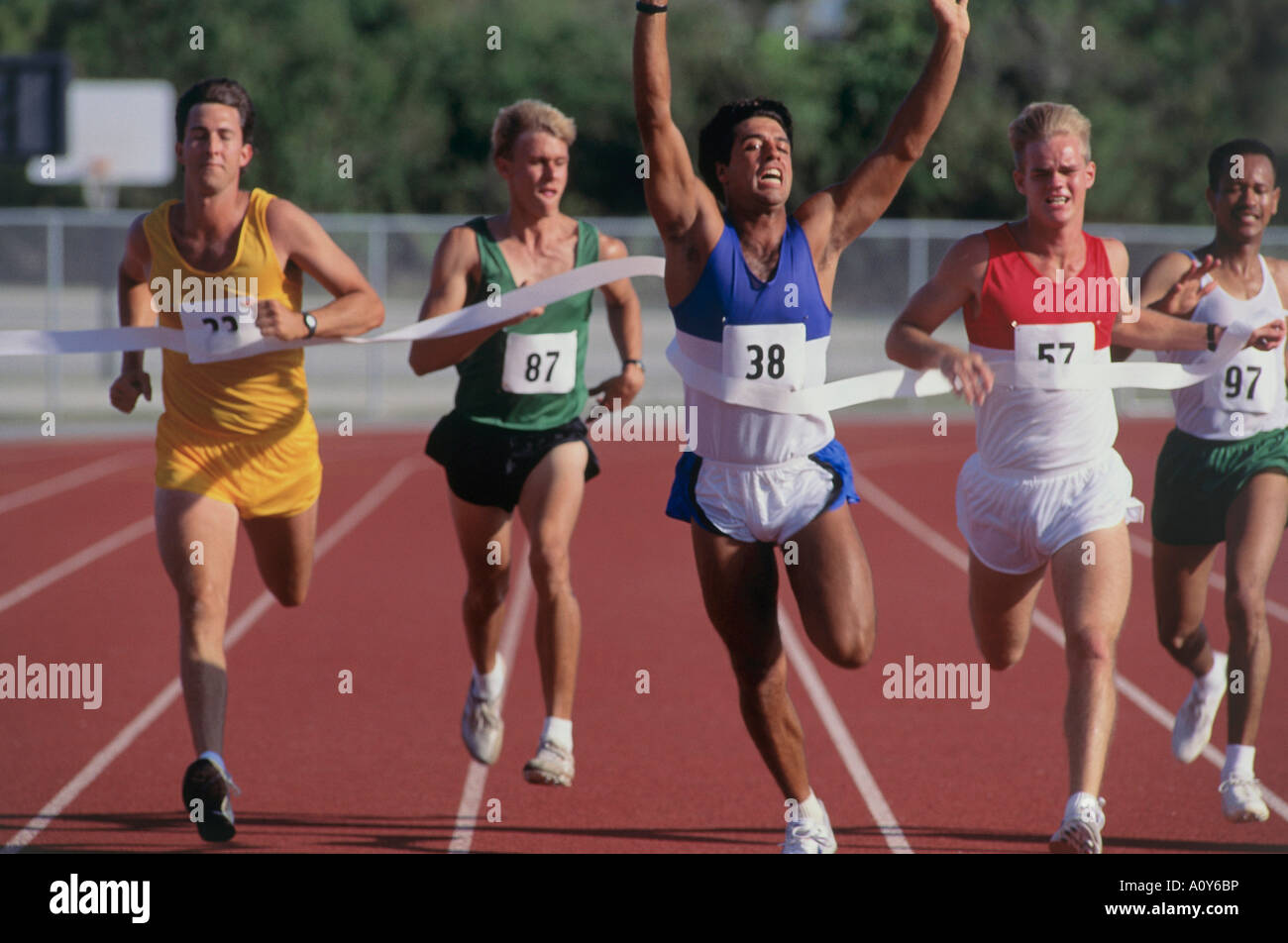 Close-up of five athletes crossing the finishing line in a race Stock ...
