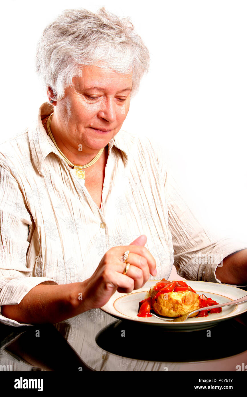 Mature Woman Eating Jacket Potato Model Released Stock Photo - Alamy