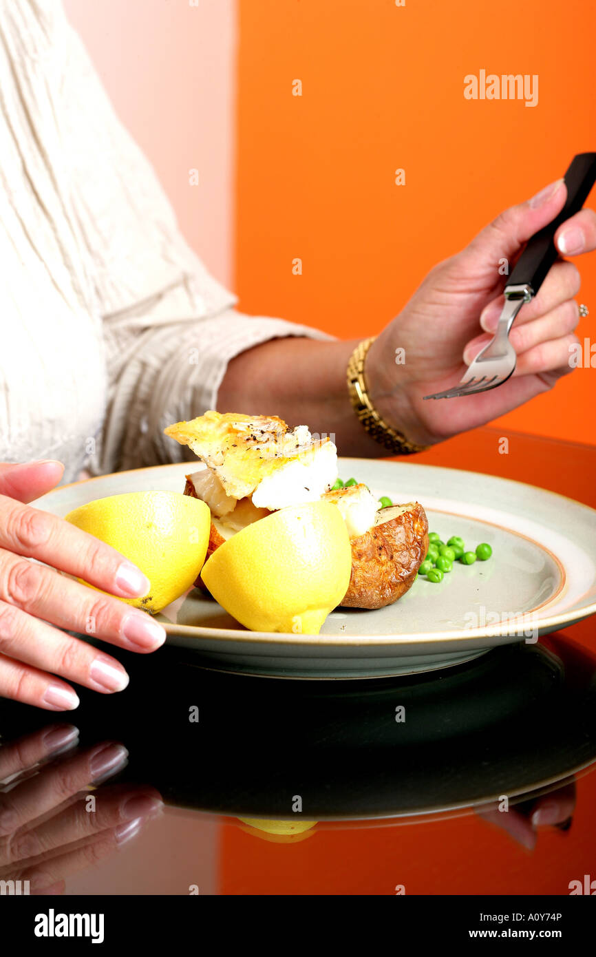 Mature Woman Eating Jacket Potato with Haddock Model Released Stock ...