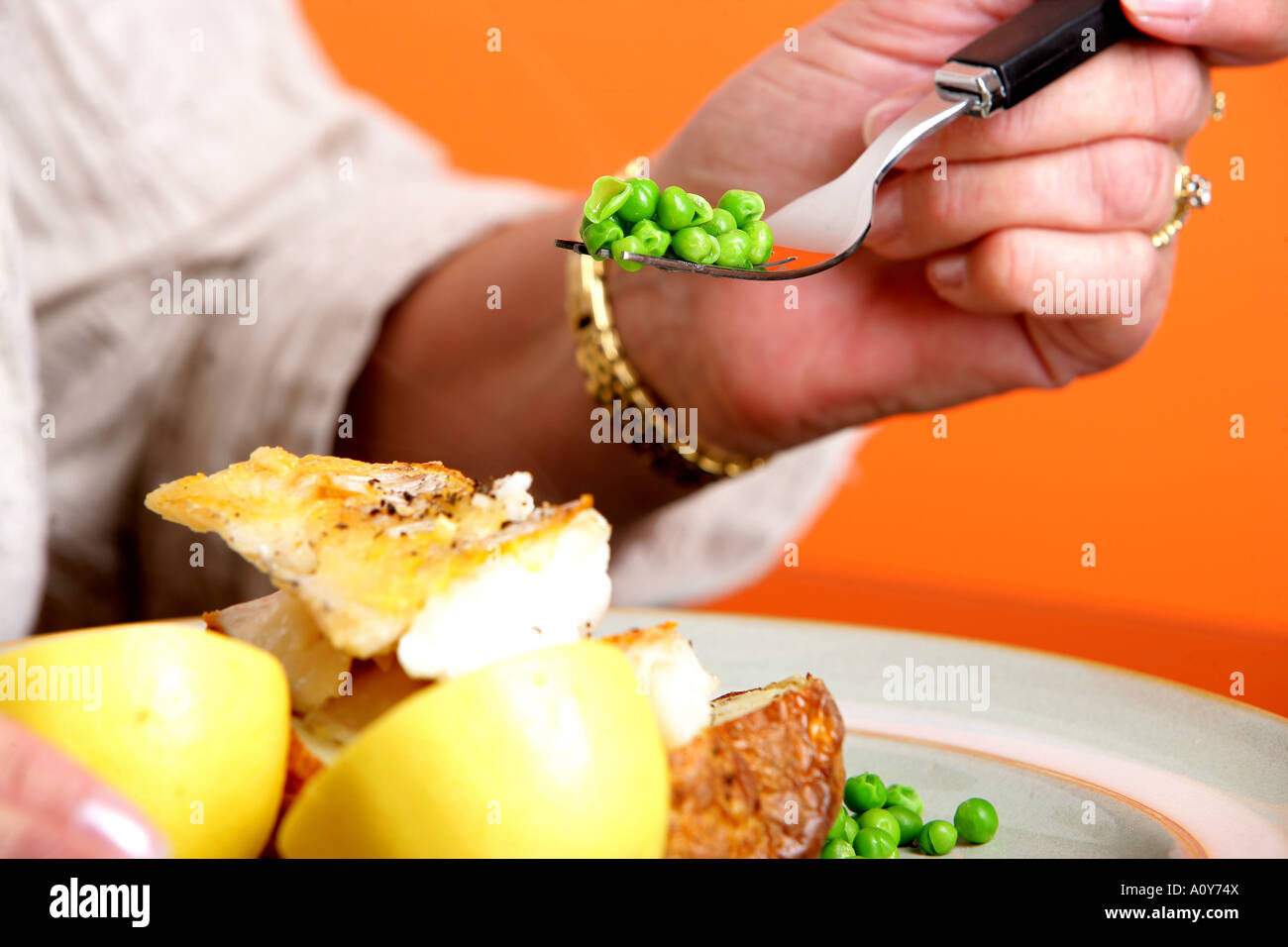 Mature Woman Eating Jacket Potato with Haddock Model Released Stock ...