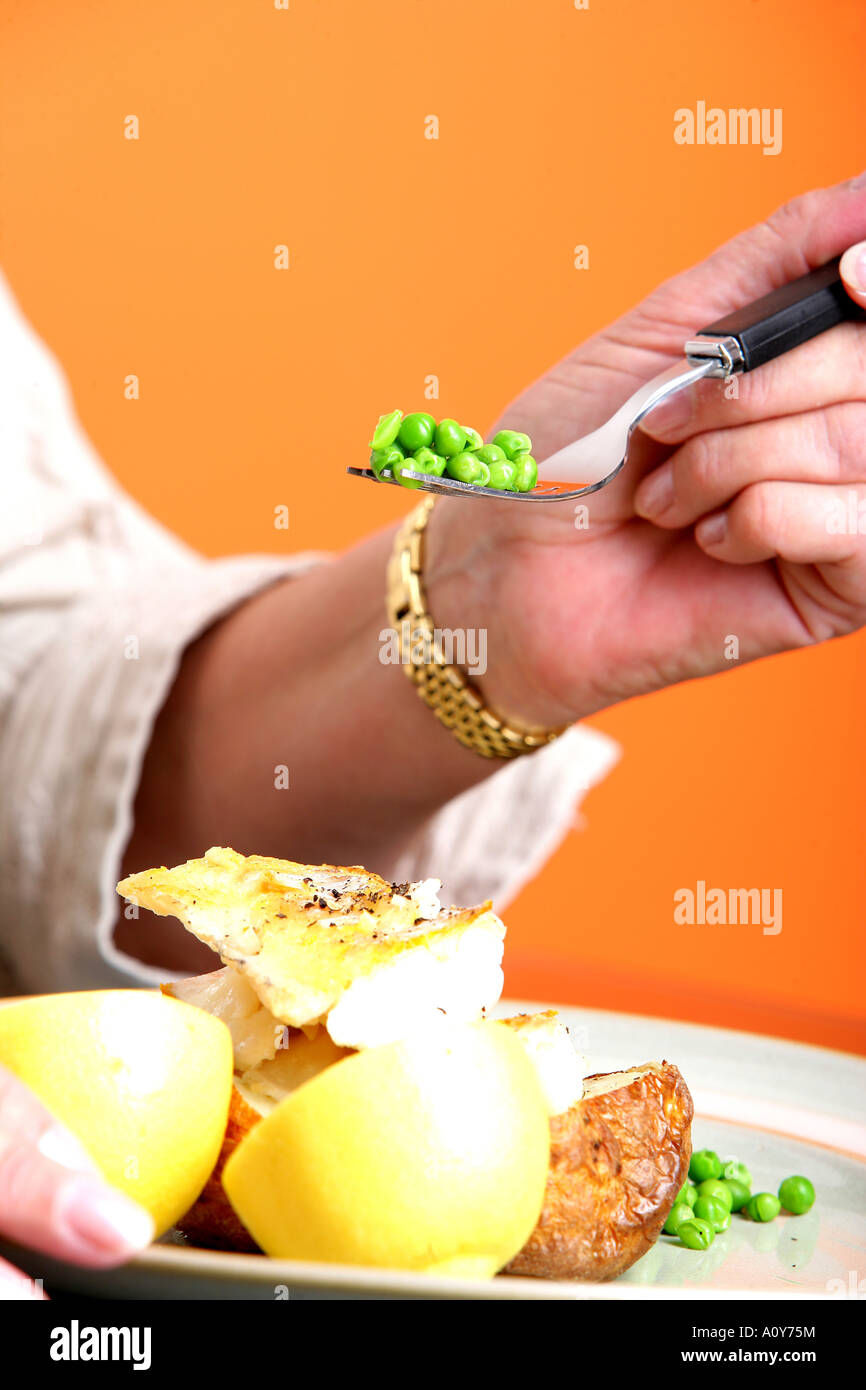 Mature Woman Eating Jacket Potato with Haddock Model Released Stock ...