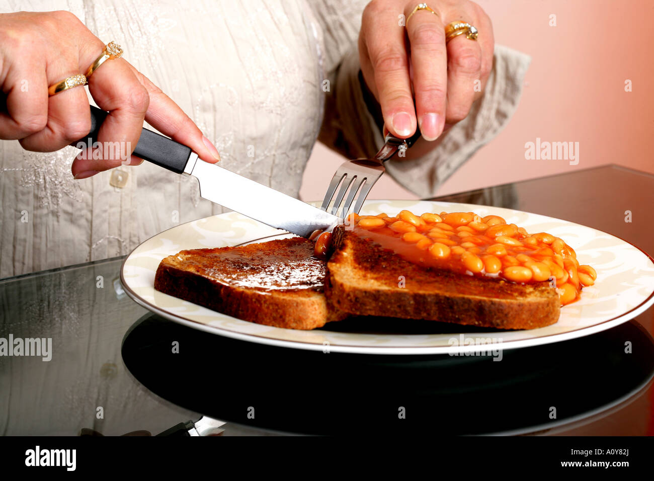 Mature Woman Eating Beans on Toast Model Released Stock Photo - Alamy