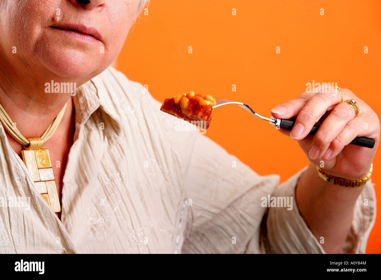 Mature Woman Eating Beans on Toast Model Released Stock Photo - Alamy