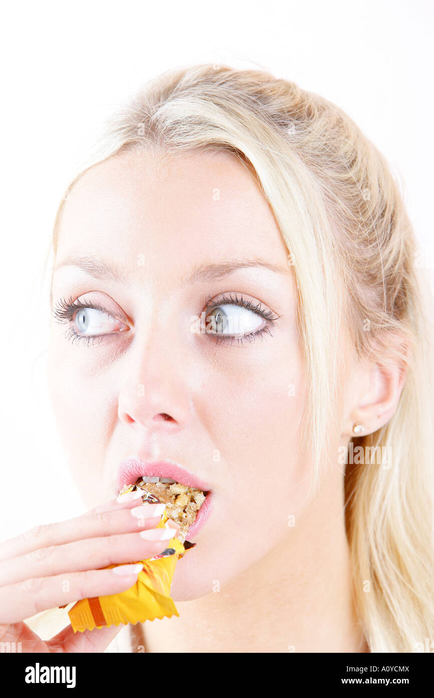 Young Woman Eating Breakfast Bar Model Released Stock Photo - Alamy