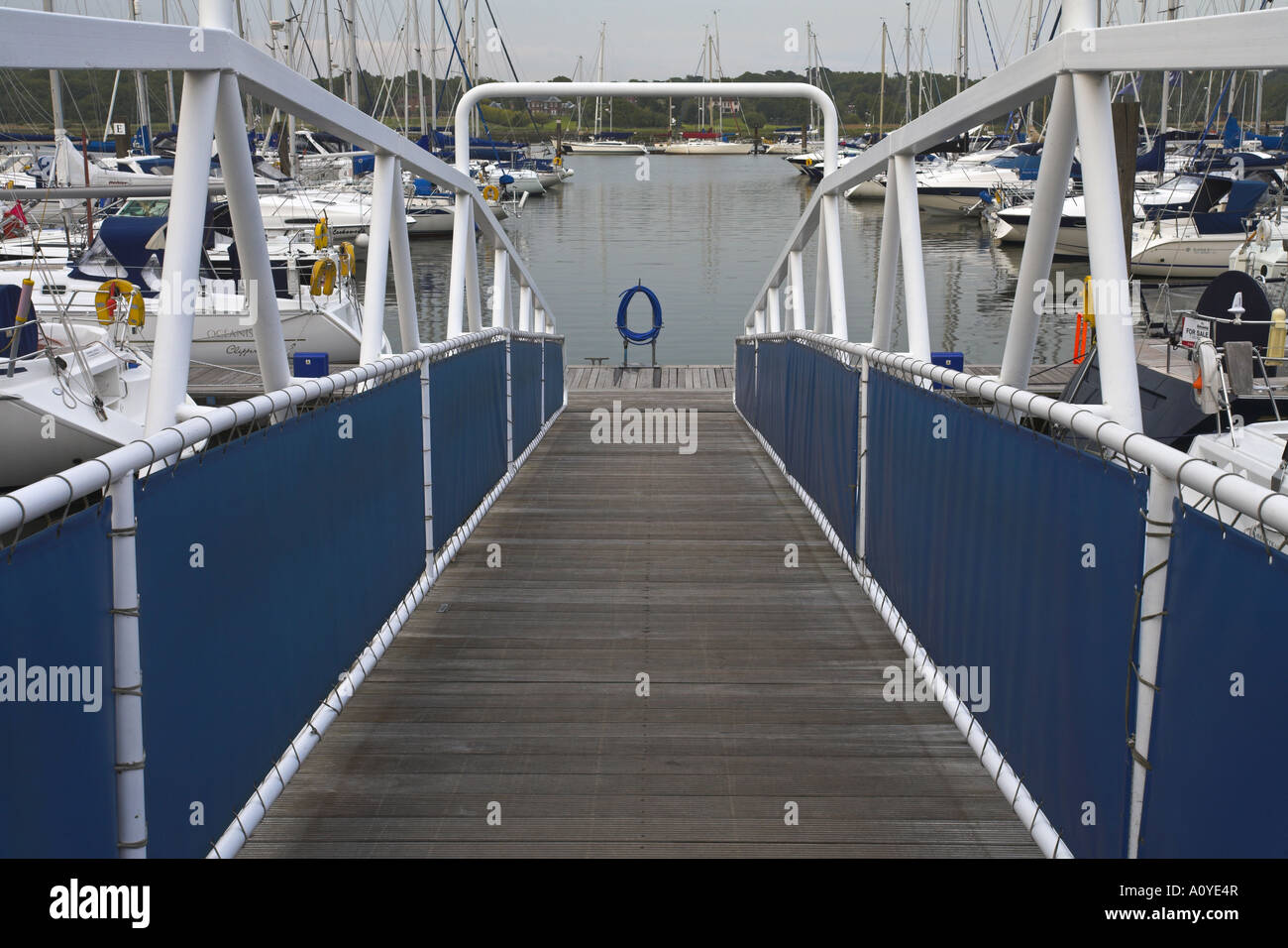 A walkway leads to the moored yachts at Port Hamble marina Stock Photo ...