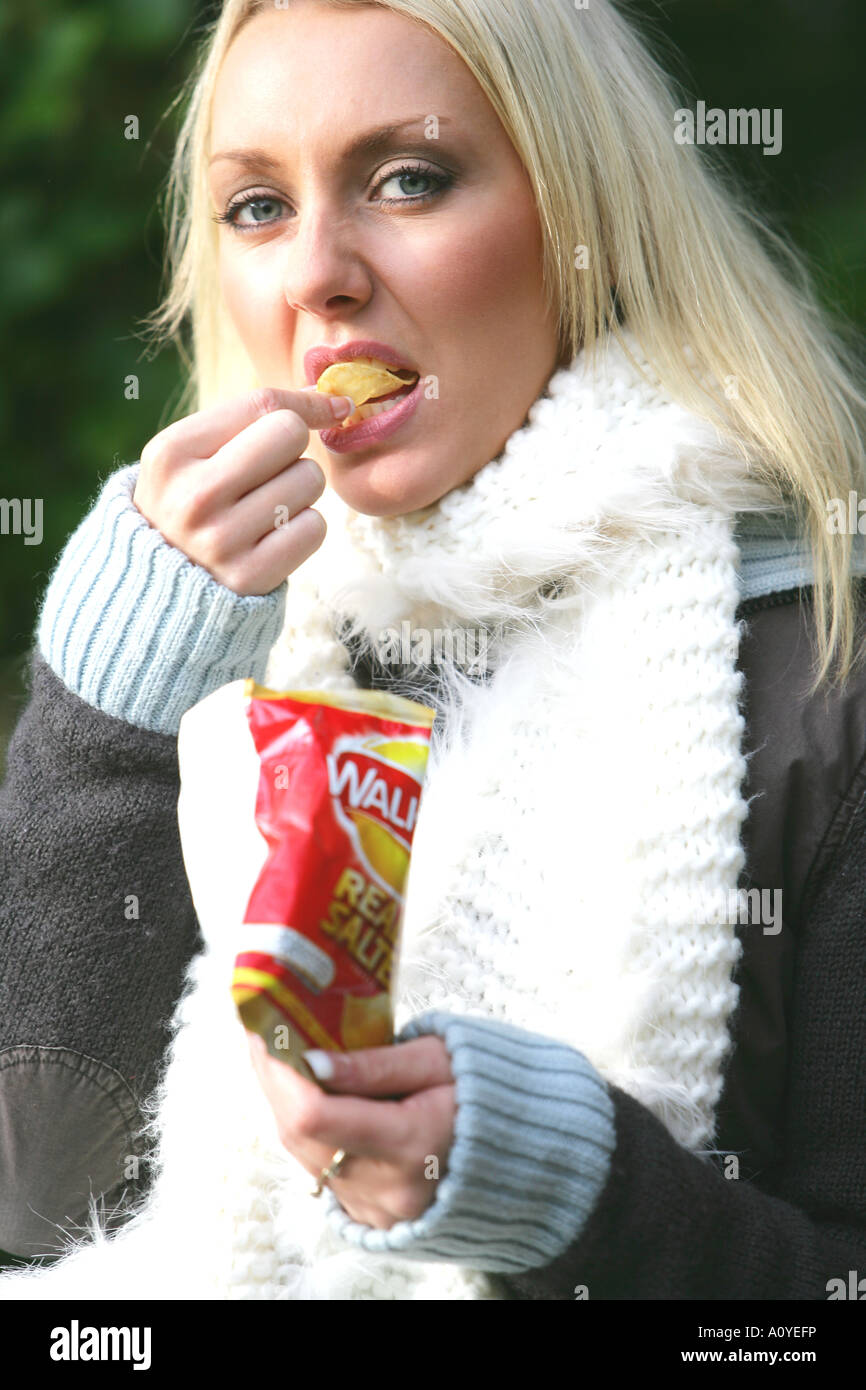 Young Woman Eating Crisps in a Park Model Released Stock Photo - Alamy