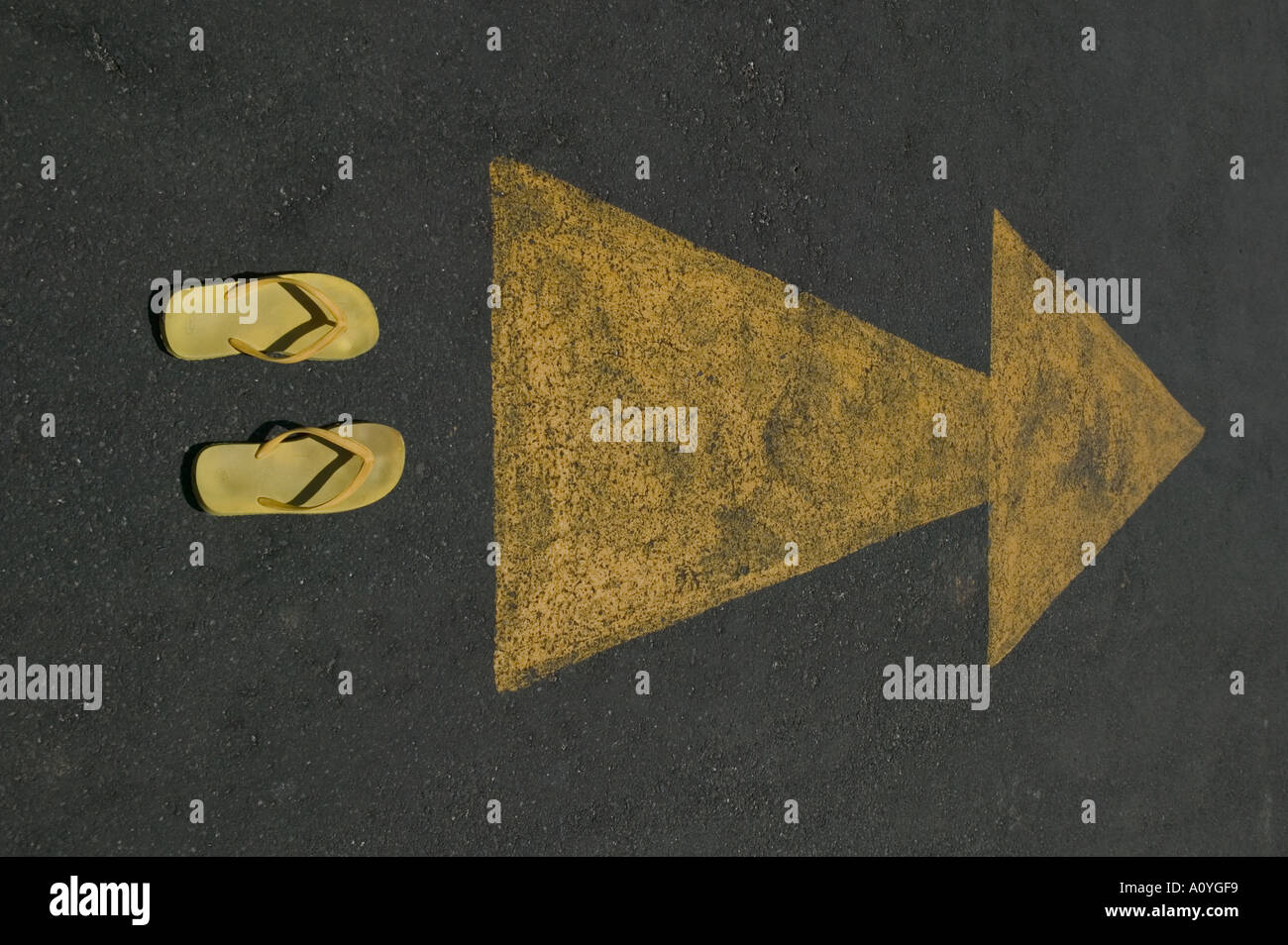 Yellow arrow and yellow flip flops Stock Photo - Alamy