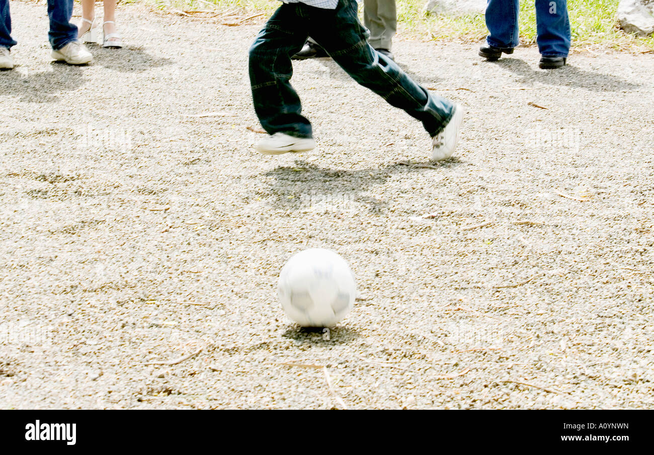Boy running for soccer ball Stock Photo - Alamy