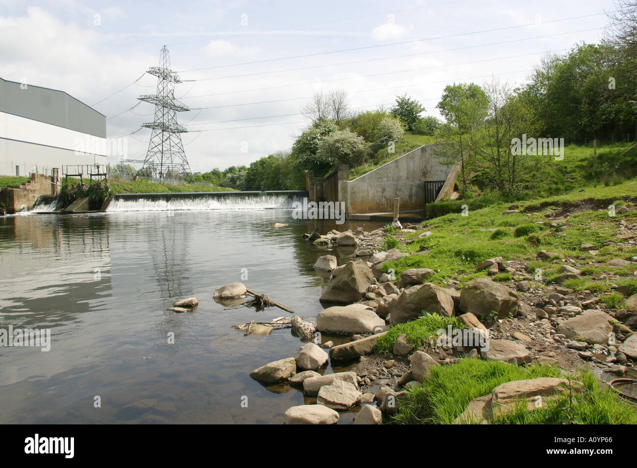 weir and drain outfall on river in urban area Stock Photo - Alamy